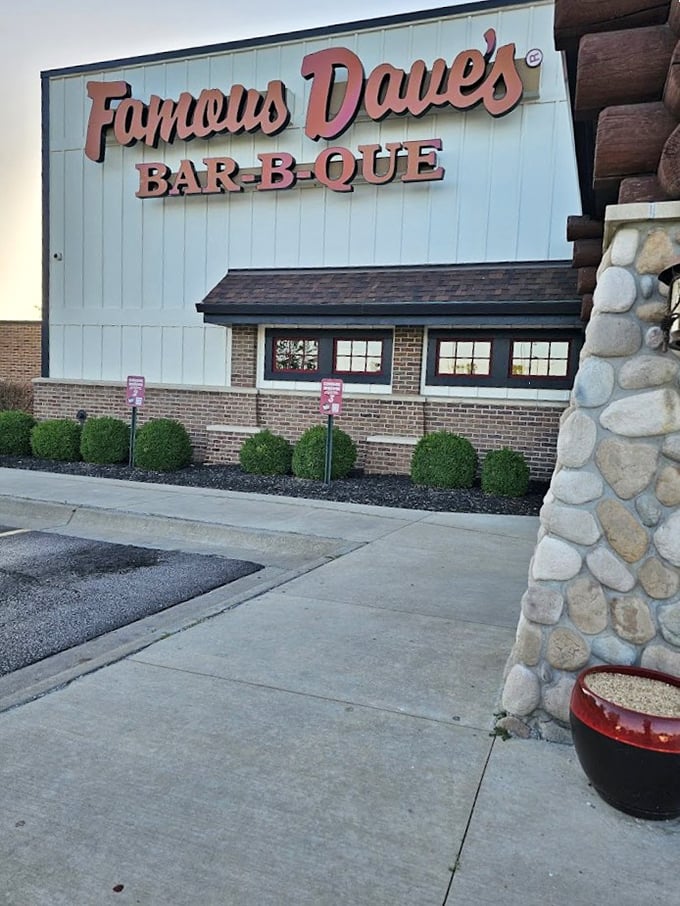Famous Dave's Bar-B-Que: "Stone columns, rustic wood exterior. Inside, they're serving the kind of BBQ that makes you forget your table manners."