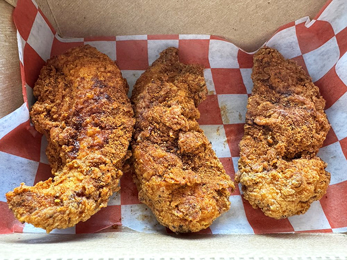 Three perfect tenders displaying that signature cragginess that promises maximum crunch. Fried chicken perfection doesn't require anything fancy&mdash;just technique and respect.