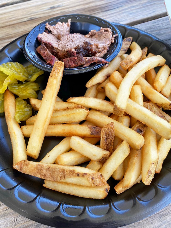 Brisket sliced thick enough to show off its smoke ring, paired with golden fries &ndash; proof that simplicity often trumps complexity.