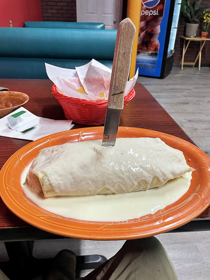 A burrito that needed its own zip code, smothered in cheese sauce that's practically auditioning for its own Food Network special.