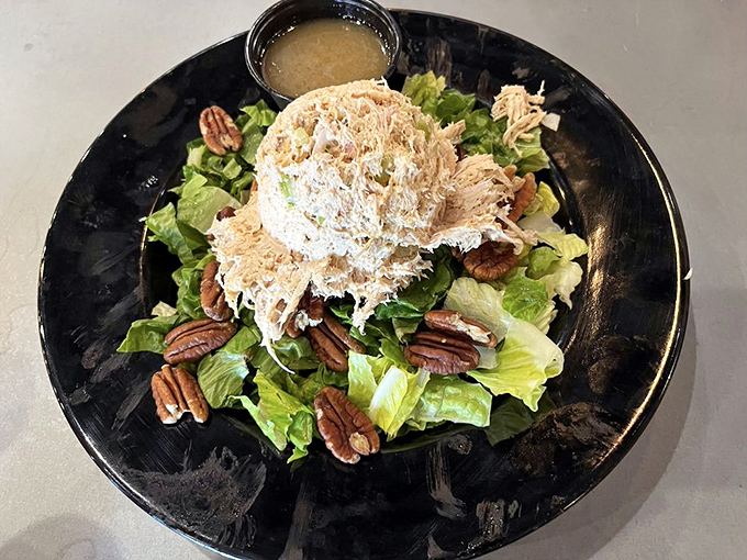 Even the salad gets the royal treatment, crowned with pulled chicken and pecans like barbecue's sophisticated cousin.