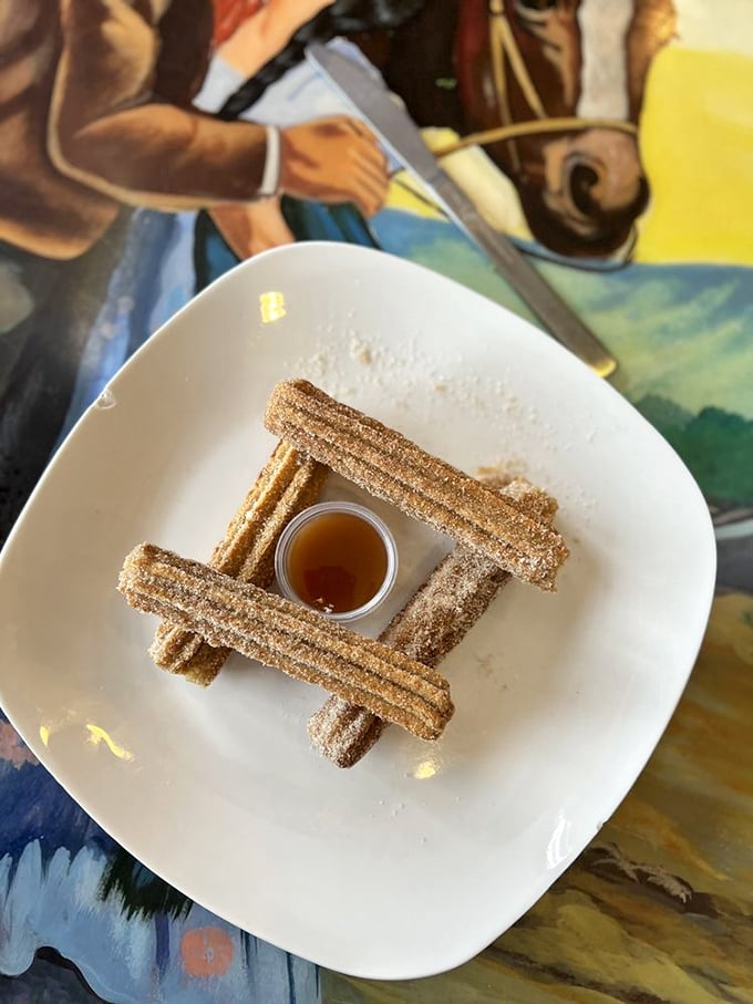 Churros arranged with architectural precision. These cinnamon-sugar wands with honey dipping sauce could make dessert skeptics reconsider their life choices.