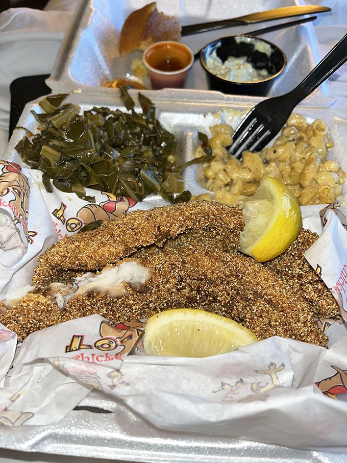 Soul food trifecta: collard greens, mac and cheese, and cornmeal-crusted catfish that tastes like someone's grandma is in the kitchen.