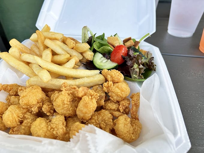 These crispy shrimp are having the best day of their lives, nestled alongside fries and a salad pretending to make this healthy.