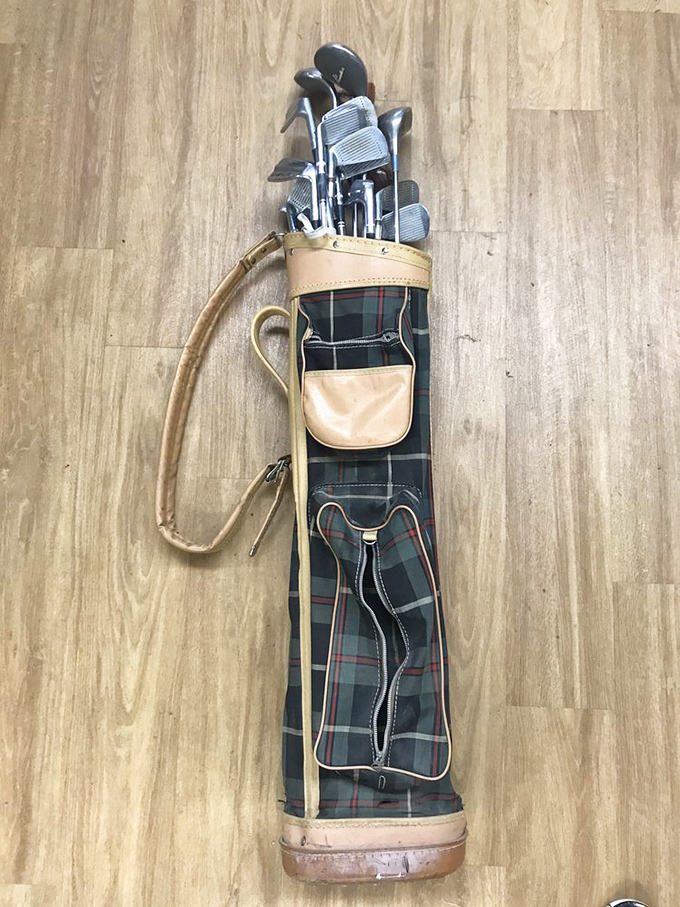 A vintage golfer's dream find! This plaid golf bag with its full set of clubs practically whispers tales of missed putts and that one perfect drive on the 17th hole.