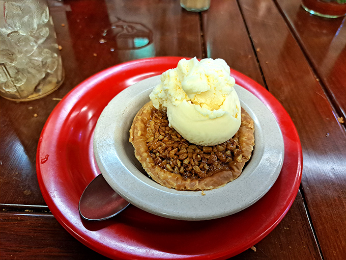 A slice of pecan heaven crowned with melting ice cream&mdash;the kind of dessert that justifies every mile of your journey.