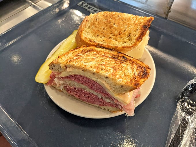 The Reuben&mdash;where sauerkraut, corned beef, and Swiss cheese achieve perfect harmony. This isn't just grilled&mdash;it's been transformed by fire and skill.