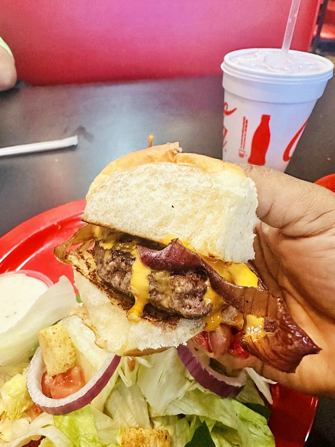 A burger that requires both hands and several napkins – the universal sign of something worth every messy bite.