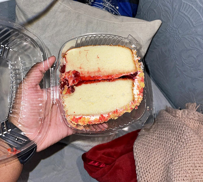 A slice of strawberry crunch cake that makes you realize dessert isn't optional—it's the reason you saved that little bit of room.