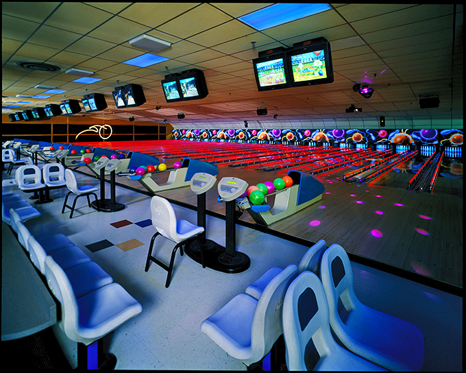 The distinctly bowling alley combination of molded plastic chairs and speckled carpet creates a time capsule that feels oddly like coming home.