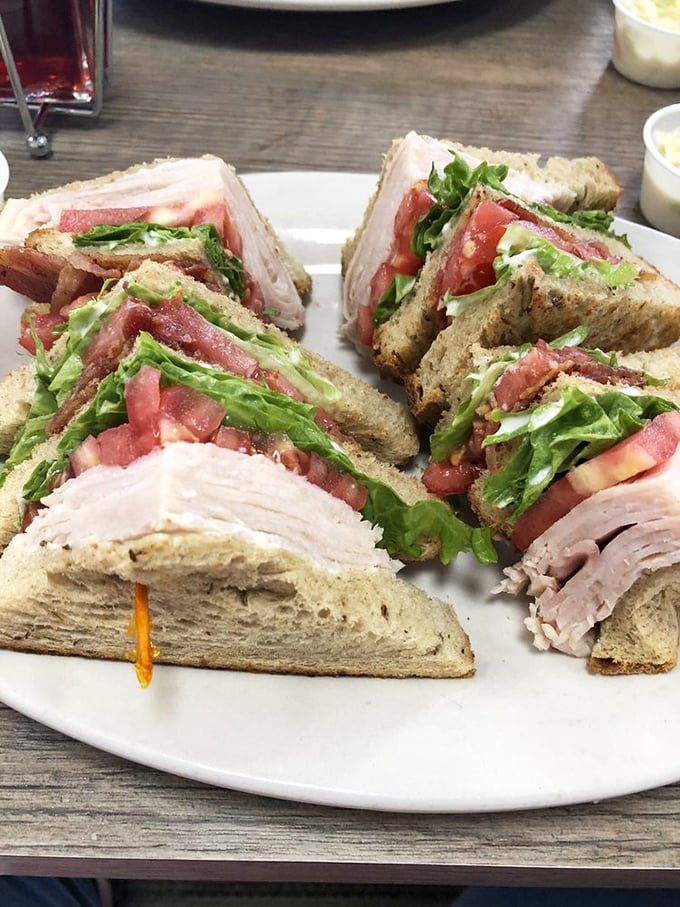 Turkey club sandwiches stacked so high they require jaw exercises&mdash;the kind of lunch that demands a nap afterward and makes it entirely worth it.