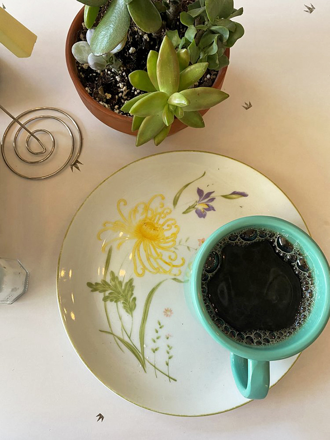 Morning rituals done right: artisanal coffee in vintage china, surrounded by greenery&mdash;a moment of zen before the day begins.