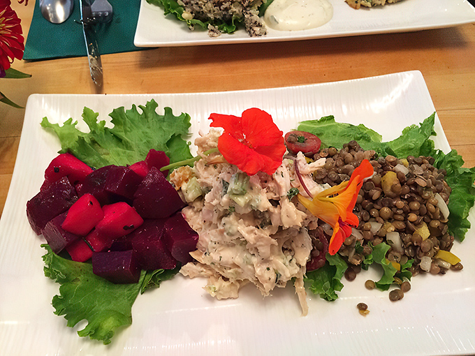 A plate that reads like a color wheel of deliciousness: vibrant beets, chicken salad, and lentils that make "eating the rainbow" a pleasure.