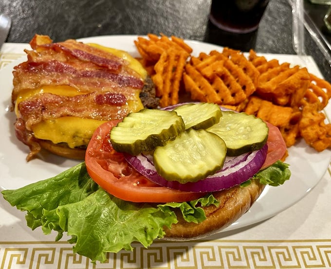 A burger that requires both hands and a strategy. Those bacon strips aren't just toppings&mdash;they're a declaration of delicious intent.