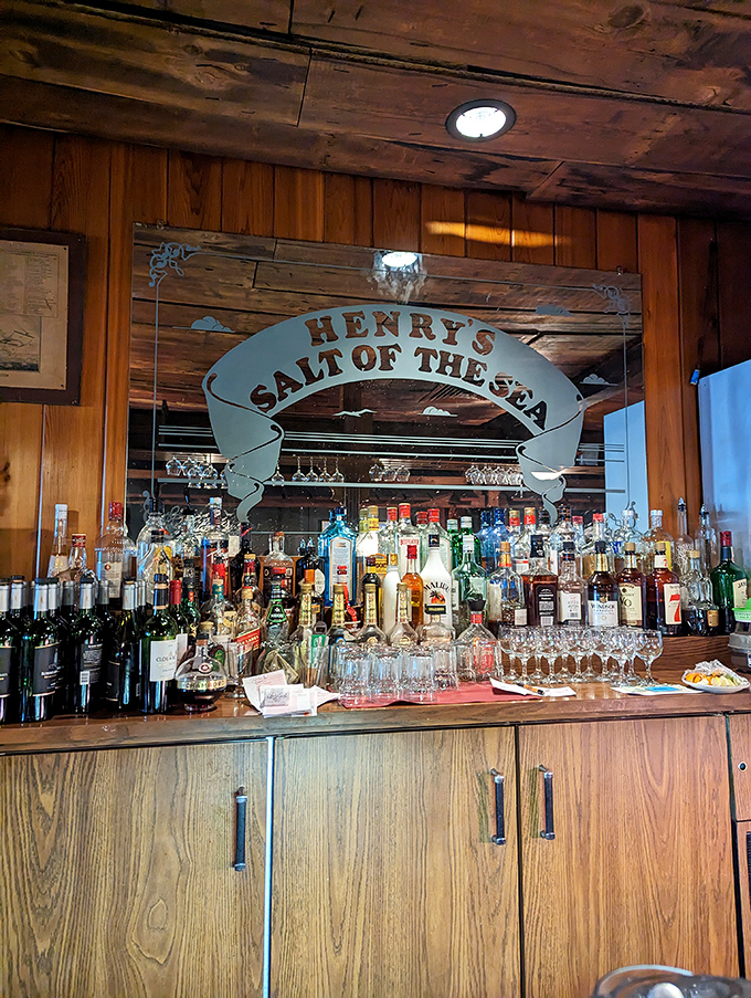 The bar at Henry's doesn't just serve drinks&mdash;it serves maritime history under glass, with the restaurant's name proudly displayed like a ship's banner. 