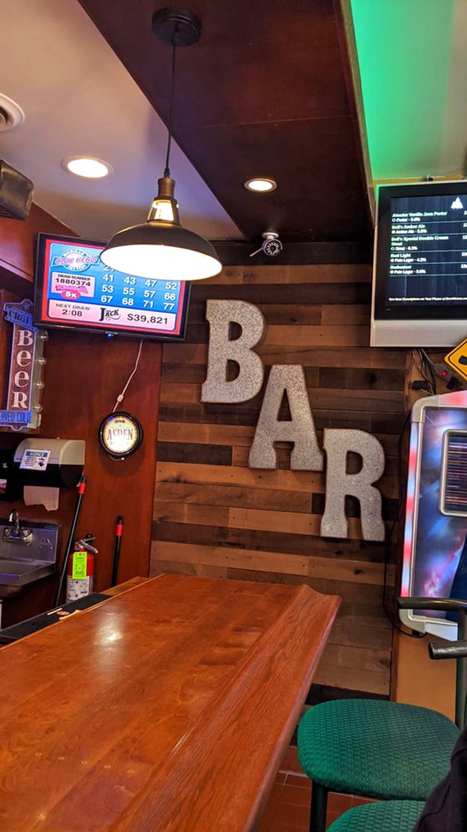 The bar area features rustic wood paneling, lottery screens, and giant metal letters spelling "BAR"&mdash;in case you somehow forgot where you were sitting.