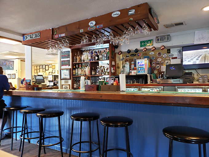 A bar where everybody might not know your name yet, but they'll remember your seafood order. Those hanging glasses await their next pour.
