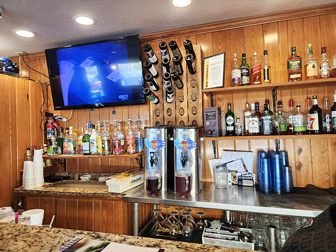 A well-stocked bar with enough options to make decisions difficult. The wood paneling continues the theme: rustic comfort with a splash of bourbon.