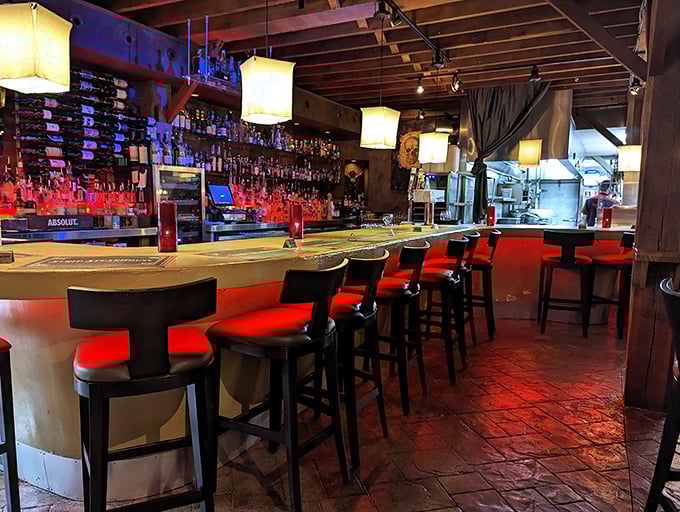 A bar that beckons you to stay awhile. Those red seats aren't just comfortable&mdash;they're strategically designed to keep you ordering "just one more."