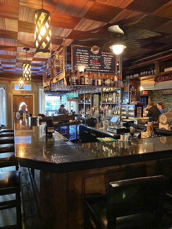 The bar's warm lighting and wood details create that magical space where "just one drink" easily becomes "another round and maybe those appetizers."