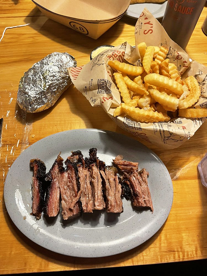 Brisket sliced thin enough to read through, yet substantial enough to carry that perfect smoke ring—the barbecue equivalent of poetry.