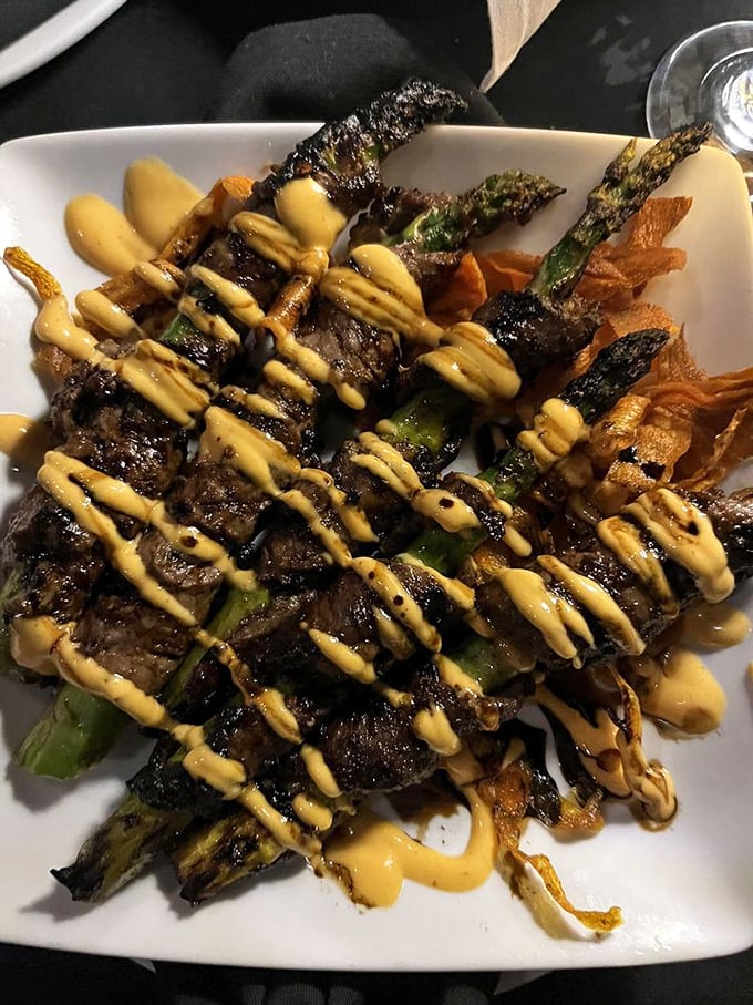 Beef-wrapped asparagus drizzled with a sauce that should be illegal. Whoever invented this deserves a Nobel Prize in deliciousness.