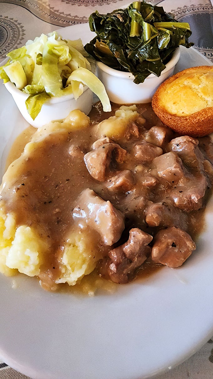 Beef tips lounging in rich gravy with mashed potatoes, cabbage, and greens&mdash;comfort food that hugs you from the inside out.
