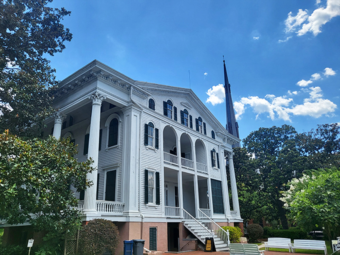 Bellamy Mansion stands as a gleaming white testament to Southern grandeur, its imposing columns reaching skyward like architectural exclamation points.