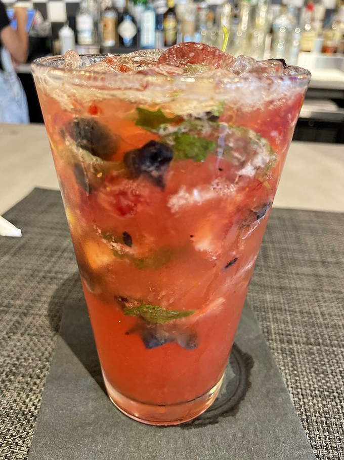 Berry lemonade that looks like it's hosting the most exclusive fruit party in town. The mint leaf got the VIP invitation.