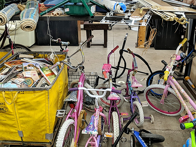 Pink bikes and yellow bins create a playground of potential. Someone's first two-wheeler is waiting here for its next adventure.