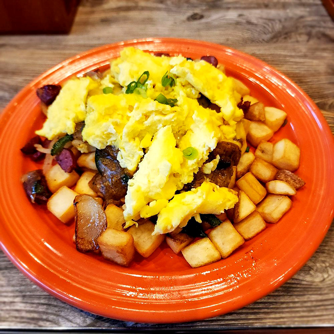 Diced potatoes, eggs, and savory treasures mingling on a coral plate like the most delicious neighborhood block party you've ever crashed.