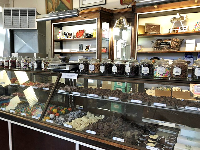 The candy counter showcases handmade chocolates and confections that make modern factory-produced sweets seem like distant relatives.