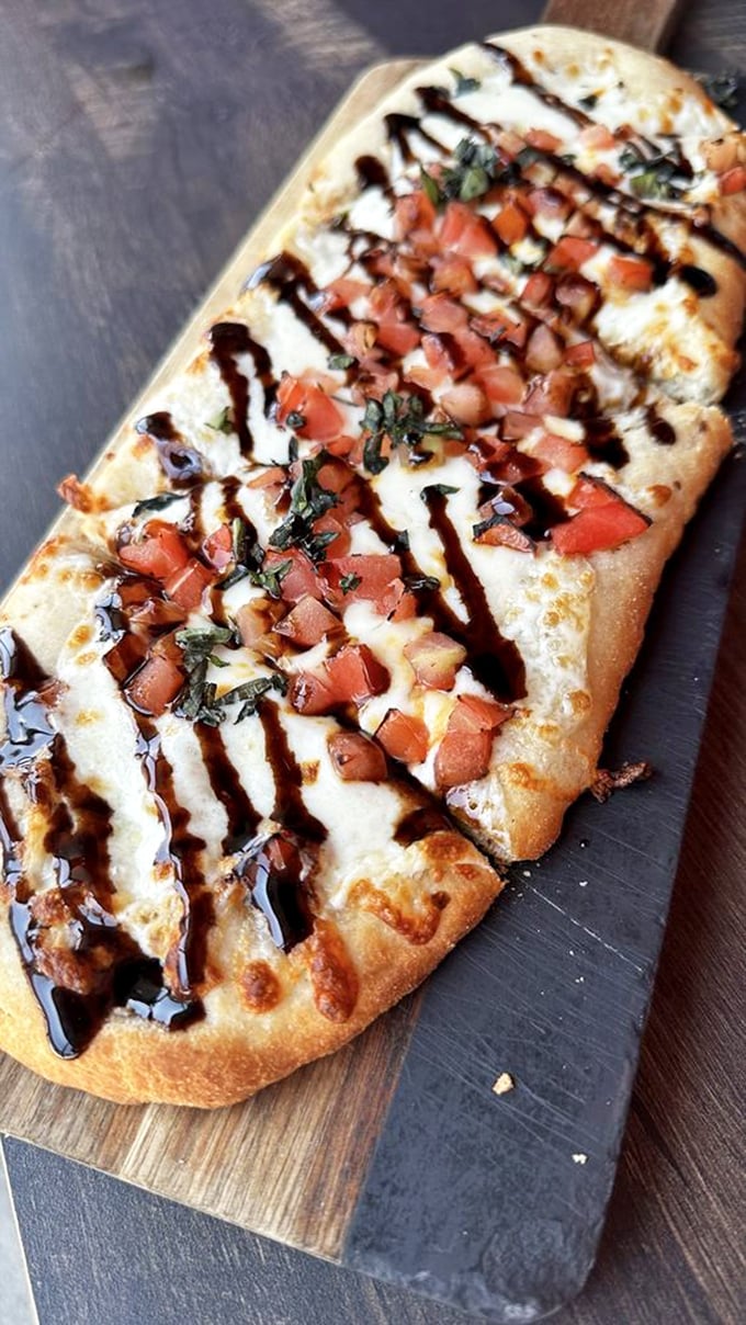 The flatbread that launched a thousand return visits, with fresh tomatoes and balsamic drizzle playing starring roles in this flavor production.