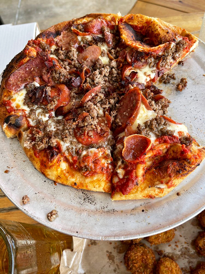 A meat lover's pizza that makes vegetarians question their life choices from three tables away. The aroma alone is persuasive.