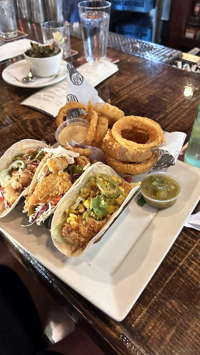 Tacos that make Tuesdays jealous of every other day. Crispy fish, fresh toppings, and those onion rings stealing the spotlight.