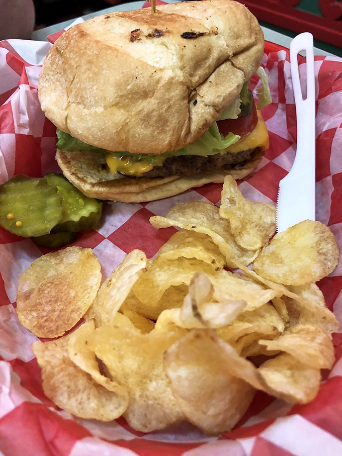 A classic burger and chips served on red-checkered paper&mdash;simple pleasures that remind us why some traditions never need updating.