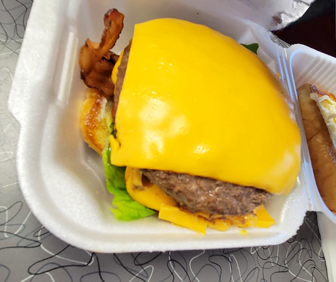 Behold the cheeseburger in its natural habitat&mdash;melted American cheese cascading over a hand-formed patty on a fresh bun with crisp lettuce.