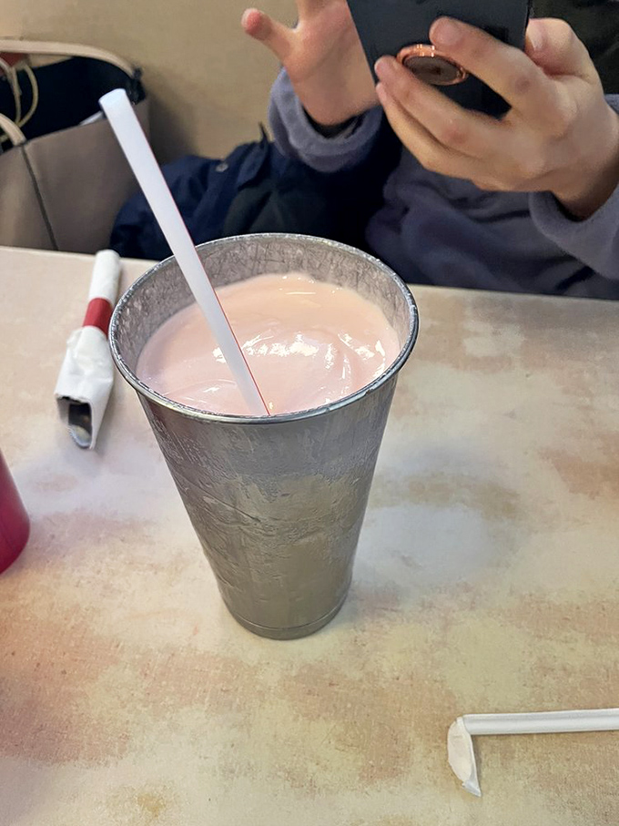The cherry milkshake comes in a cup so frosty it practically has its own microclimate. This isn't just a drink; it's a dessert with sipping privileges.