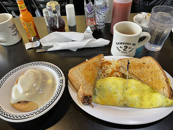 Biscuits and gravy with a perfectly fried egg—where the sunny yolk waits to break like a delicious sunrise over a landscape of creamy comfort.