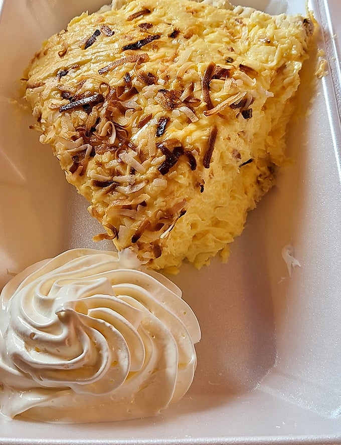 Coconut cream pie with a cloud of whipped cream&mdash;the kind of dessert that makes you consider ordering a second slice before finishing the first.