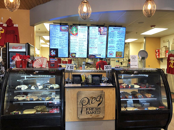 The display cases standing like sentries guarding treasures. "Fresh Baked Pies" isn't just a sign, it's a sacred promise to the hungry masses.