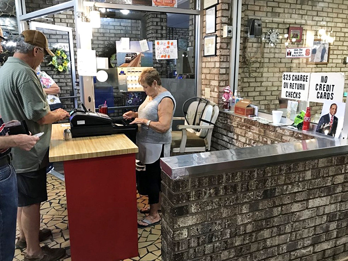 The heartbeat of Pam's Farmhouse&mdash;where orders are called, tabs are settled, and regulars always get a "hey, sugar" greeting.