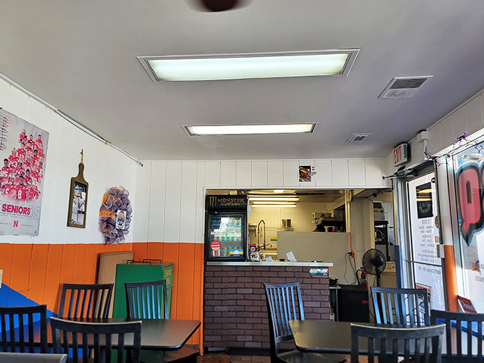 The ordering counter&mdash;that magical threshold where hunger meets its match. Orange walls frame the gateway to satisfaction.