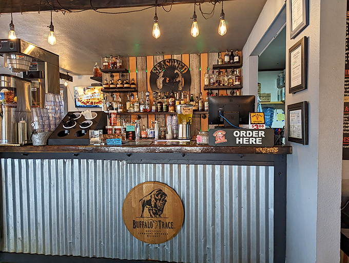 The bar area says "stay awhile" with its rustic-industrial charm. That Buffalo Trace barrel front suggests they take their whiskey as seriously as their barbecue.