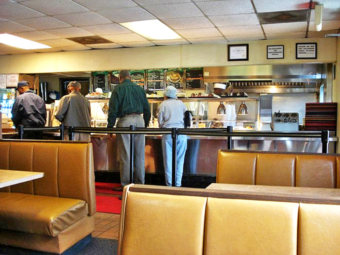 The counter where magic happens. Notice how the regulars lean in with anticipation, like concert-goers at the stage's edge.