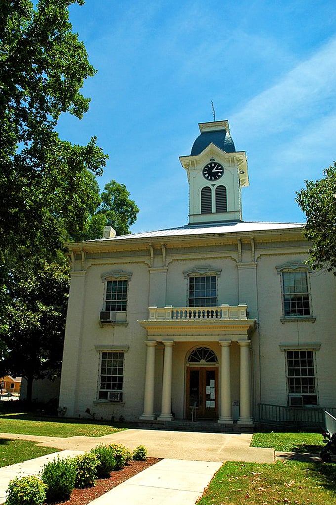 The Crawford County Courthouse stands dignified in white, its clock tower keeping watch over the town since the 19th century. Time moves differently here.
