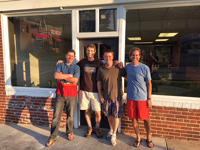 Happy pilgrims at the doorway to chicken paradise. These faces reveal the universal truth: great food creates instant communities.