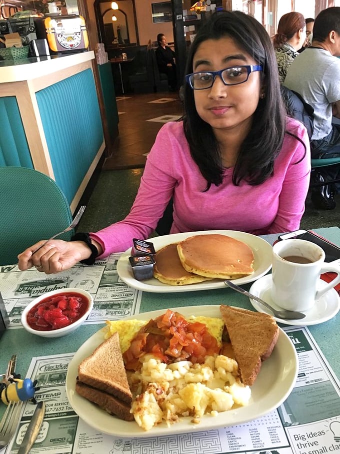 I see a plate of pancakes in your future. The diner experience is incomplete without watching someone navigate breakfast while reading the morning paper.