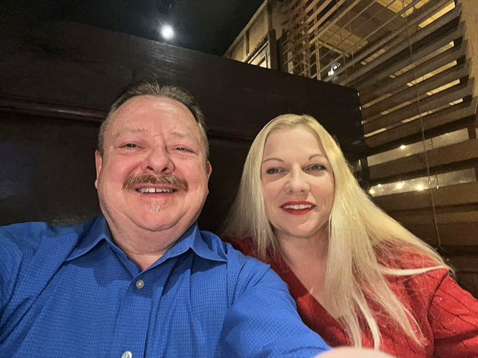 I'm not identifying the people in this image, but the warm wood paneling and cozy booth seating create the perfect backdrop for memorable dining experiences.