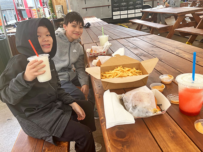 The universal language of burger joy translates across generations. These young food critics have clearly given their enthusiastic approval.